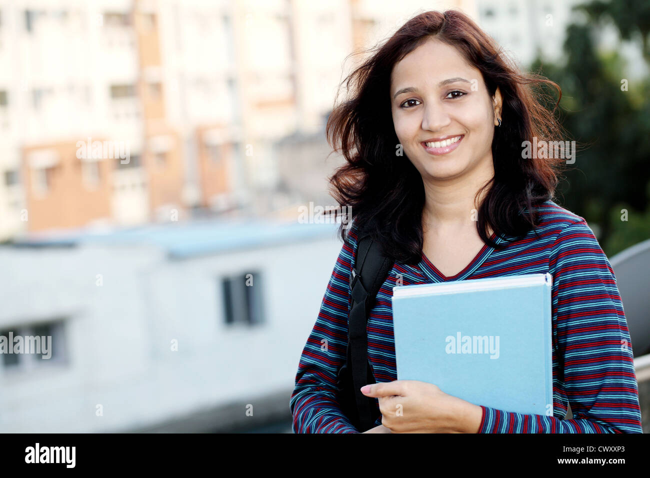 Cheerful young female college student at campus Stock Photo - Alamy