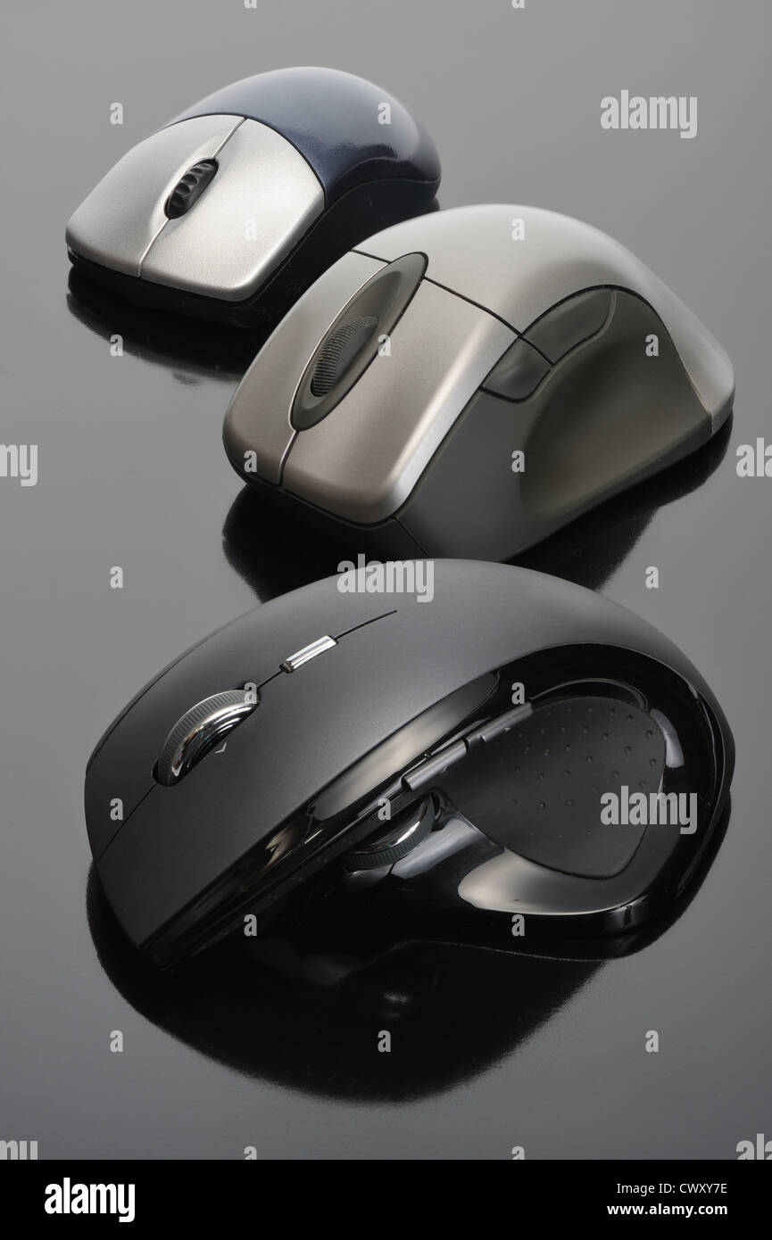 Modern wireless computer mouses on black background Stock Photo - Alamy