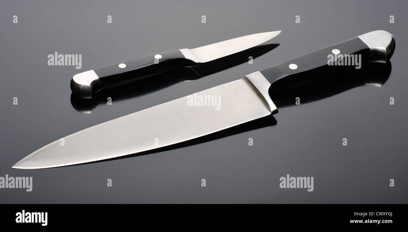 Two forged steel kitchen knife on a black background Stock Photo - Alamy