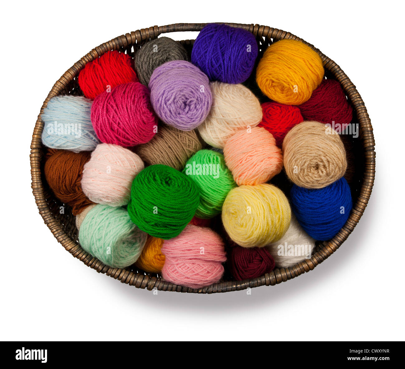 Wicker basket full of brightly coloured wool isolated on a white ...