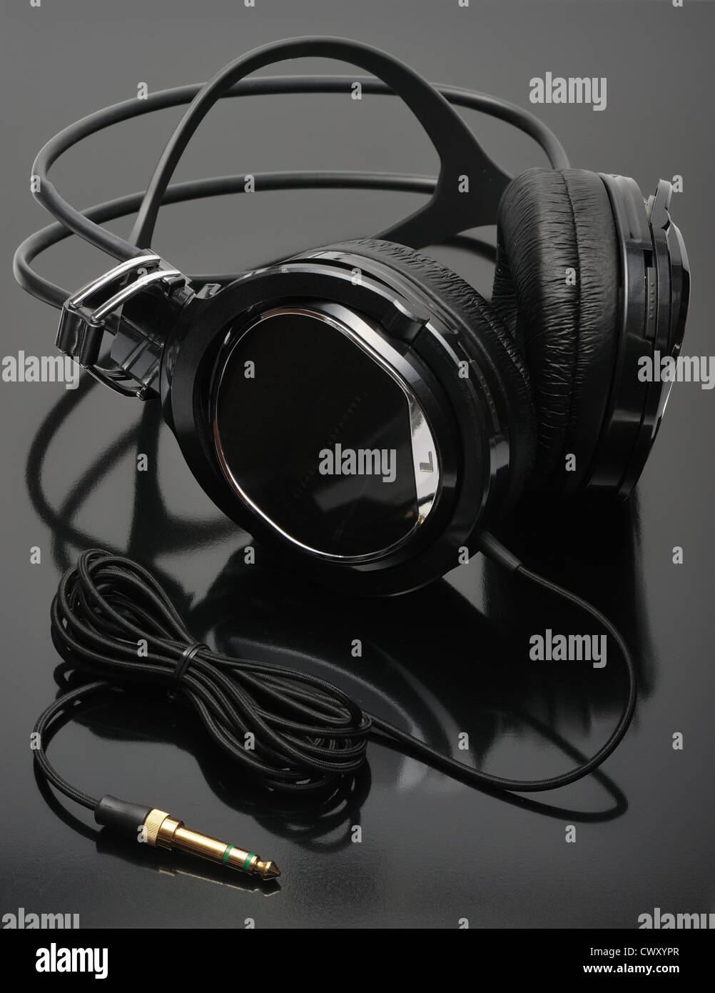 The black headphones on a black background Stock Photo - Alamy