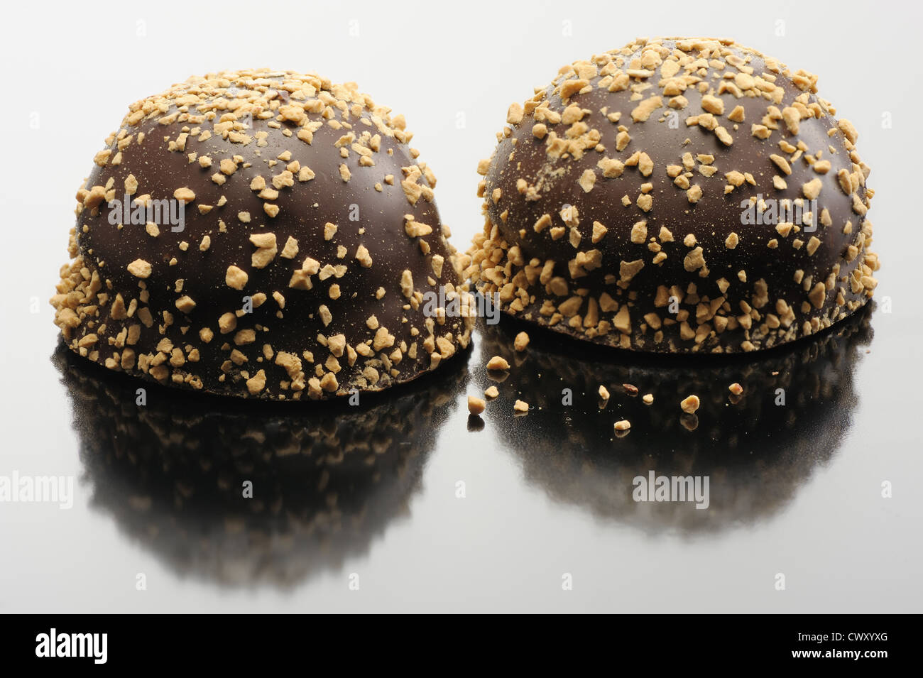 chocolate candy and their reflection on a black background Stock Photo ...