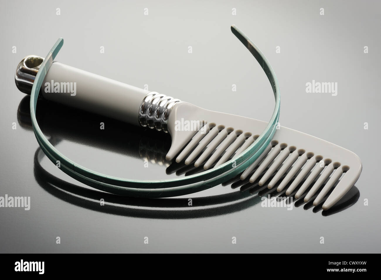 Grey comb and headband on a black background Stock Photo - Alamy