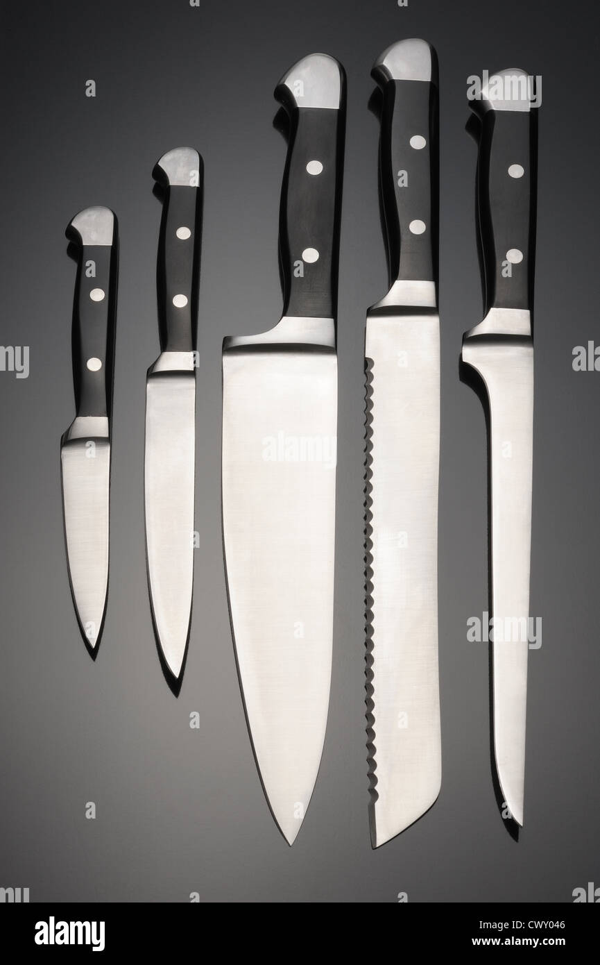 Set of forged steel kitchen knife on a black background Stock Photo - Alamy