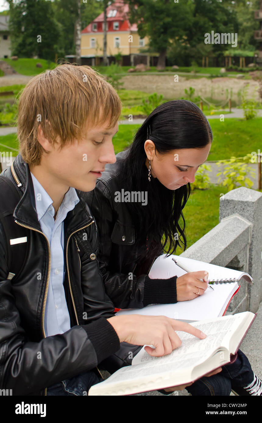 Two students studying outdoors Stock Photo - Alamy