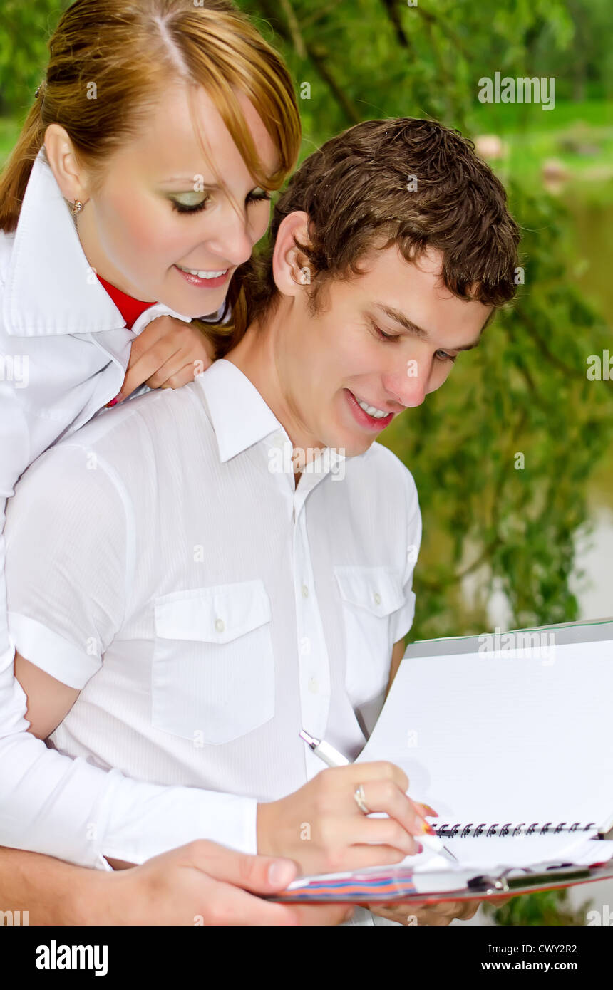Two students studying outdoors Stock Photo - Alamy