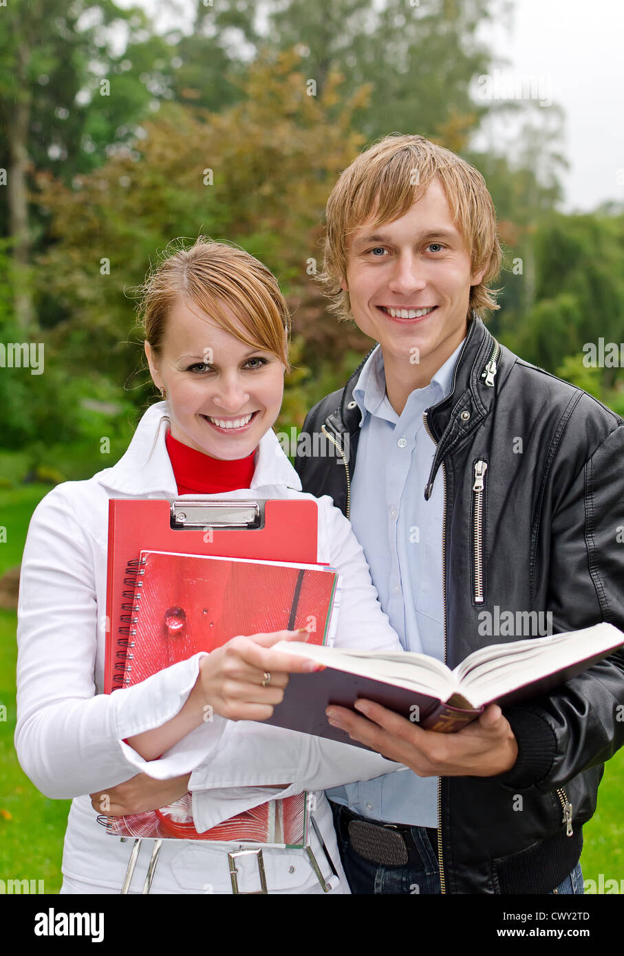 Two students studying outdoors Stock Photo - Alamy