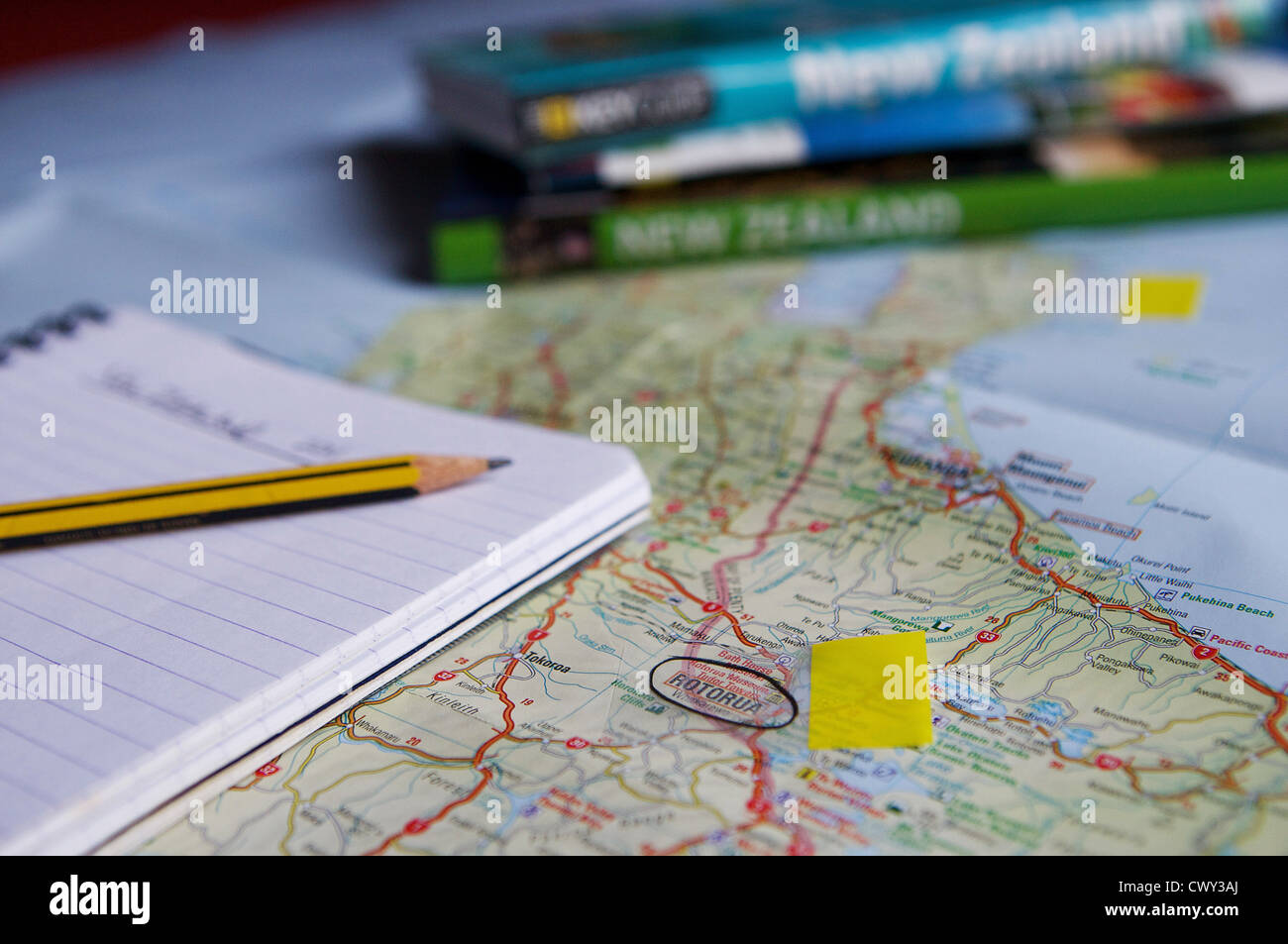 Planning a vacation or road trip. Notepad, map and tour books at the ...