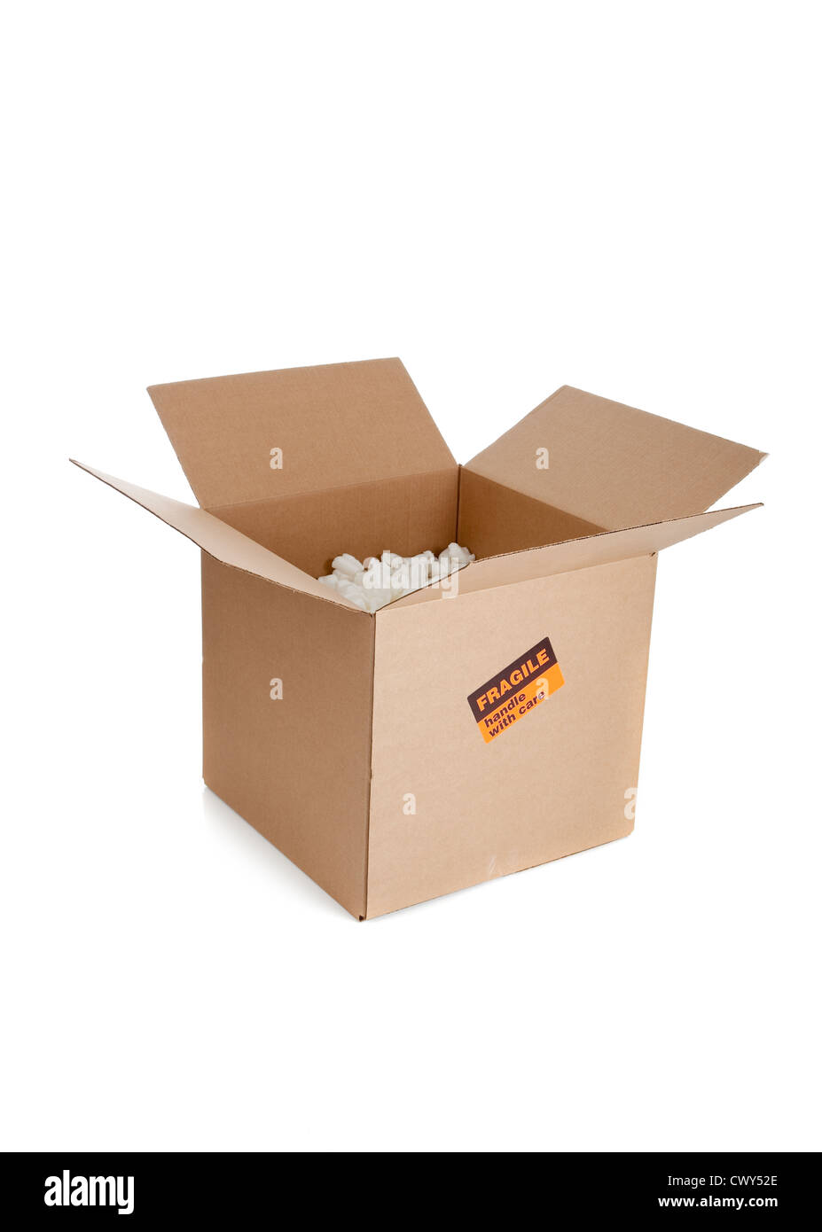 An opened brown packing box with an orange fragile sticker with ...