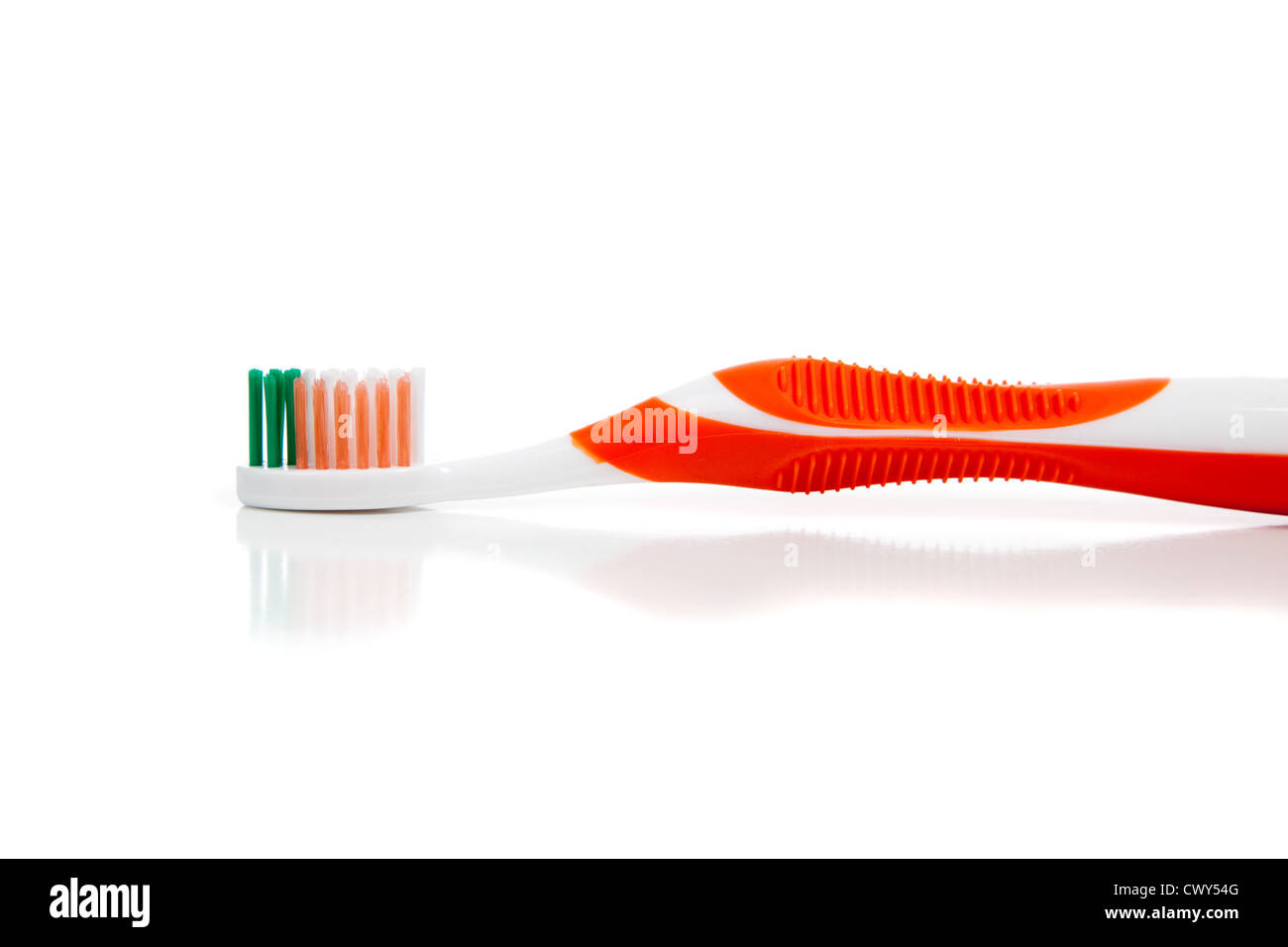 An orange toothbrush on a white background Stock Photo - Alamy