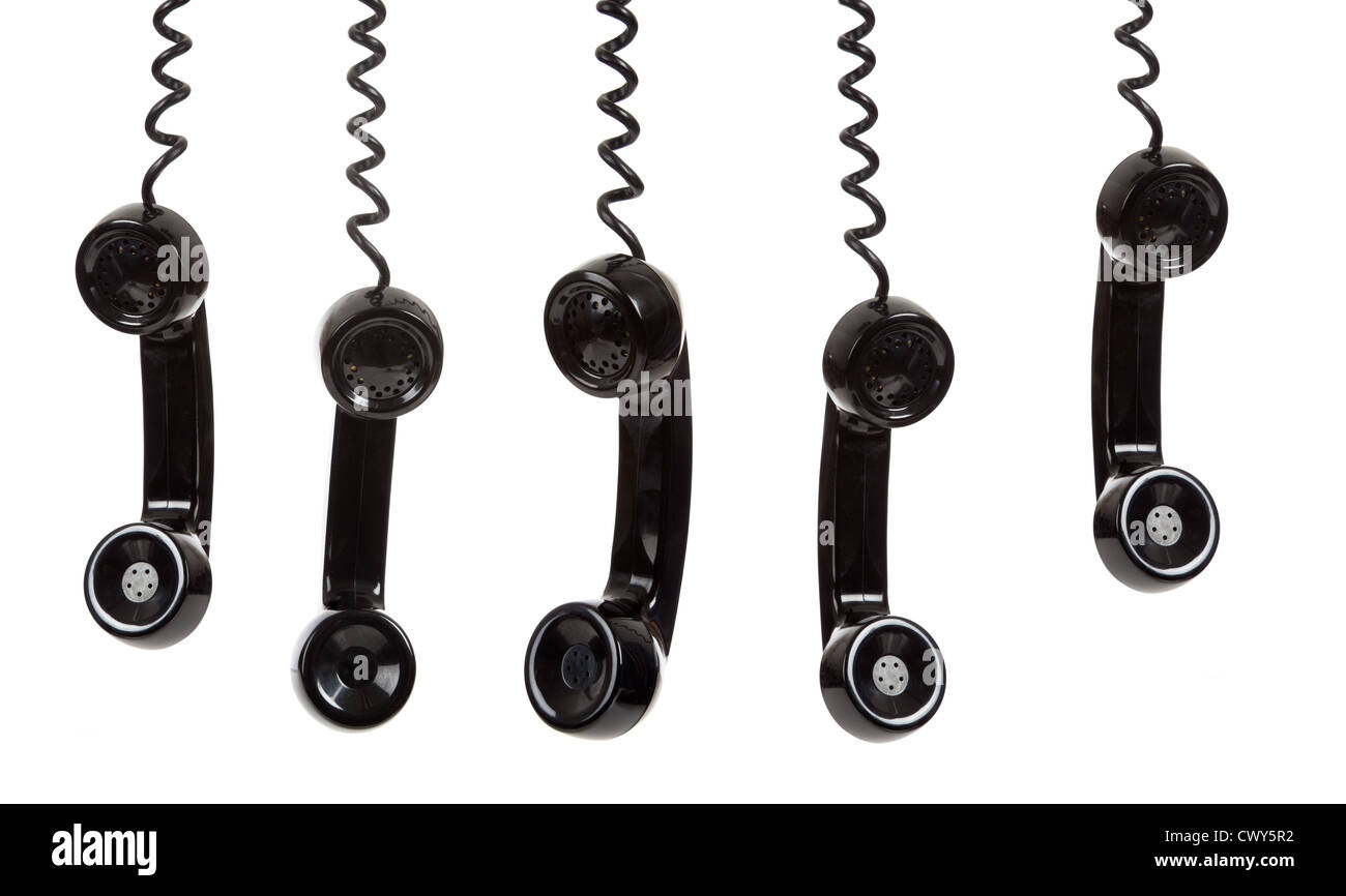A row of hanging black telephone receivers on a white background Stock ...