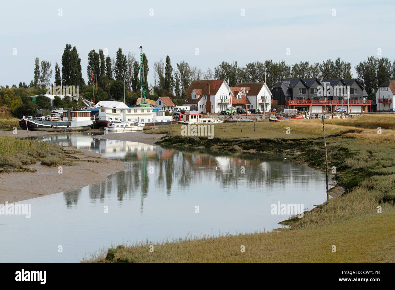 Conyer creek with houses and boats as the tide comes in Stock Photo - Alamy