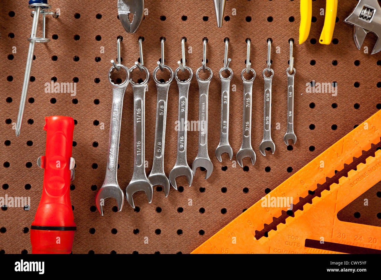 a peg board with assorted wrenches and various tools Stock Photo - Alamy