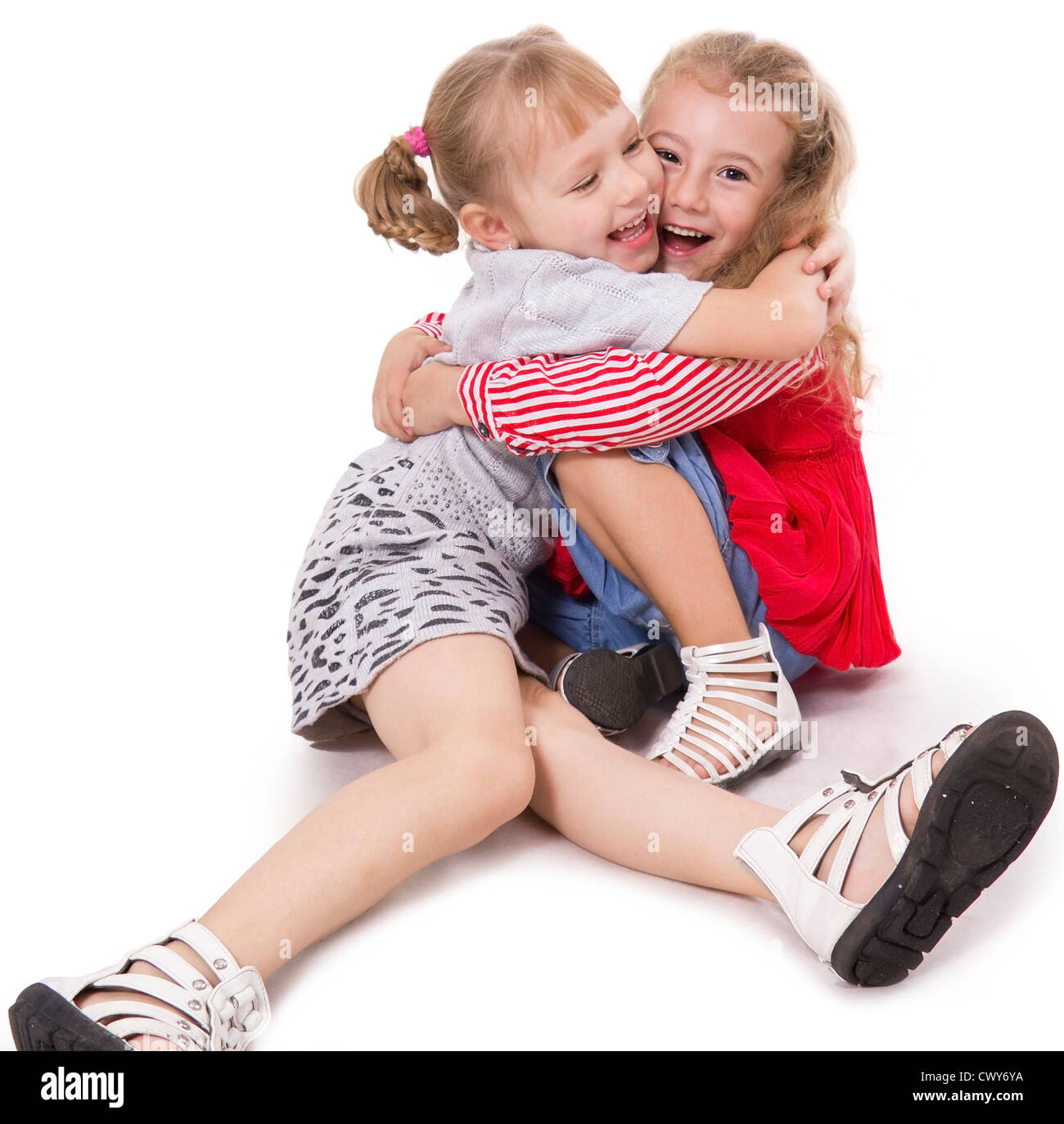 Two fun girls of the girlfriend play. White isolated Stock Photo - Alamy