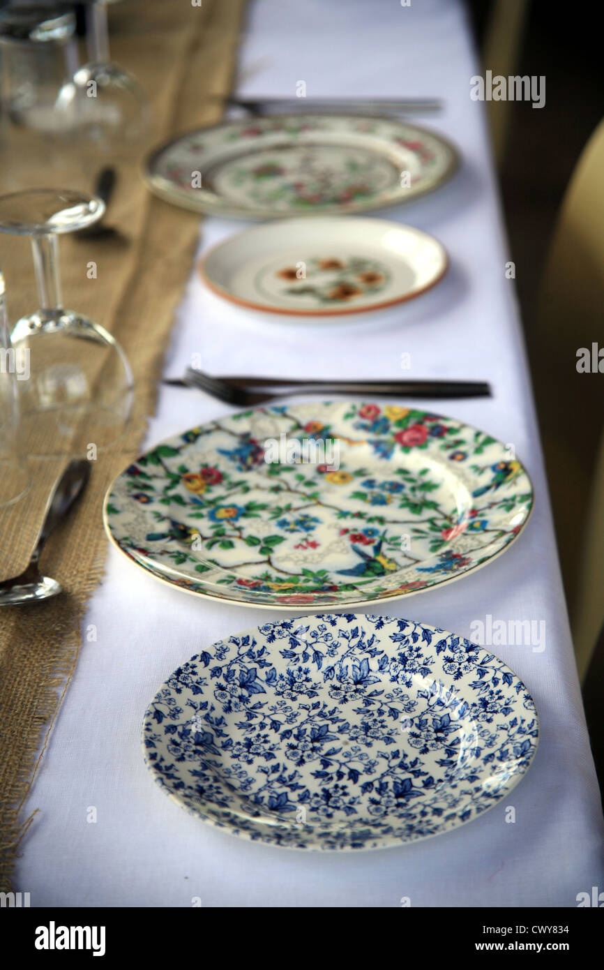 Table laid with old fashioned plates Stock Photo - Alamy