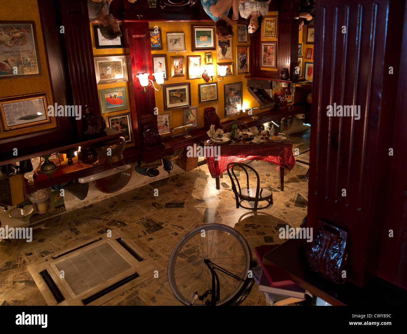 Upside down interior of restaurant with furniture fixed to the ceiling ...