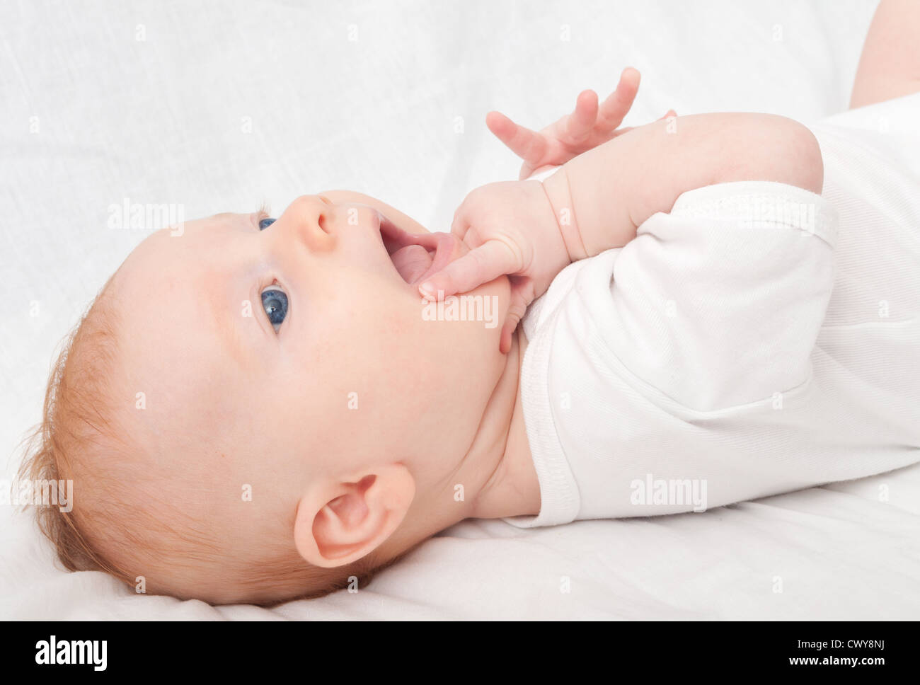 Newborn Baby Lying on Back on White Background Stock Photo - Alamy