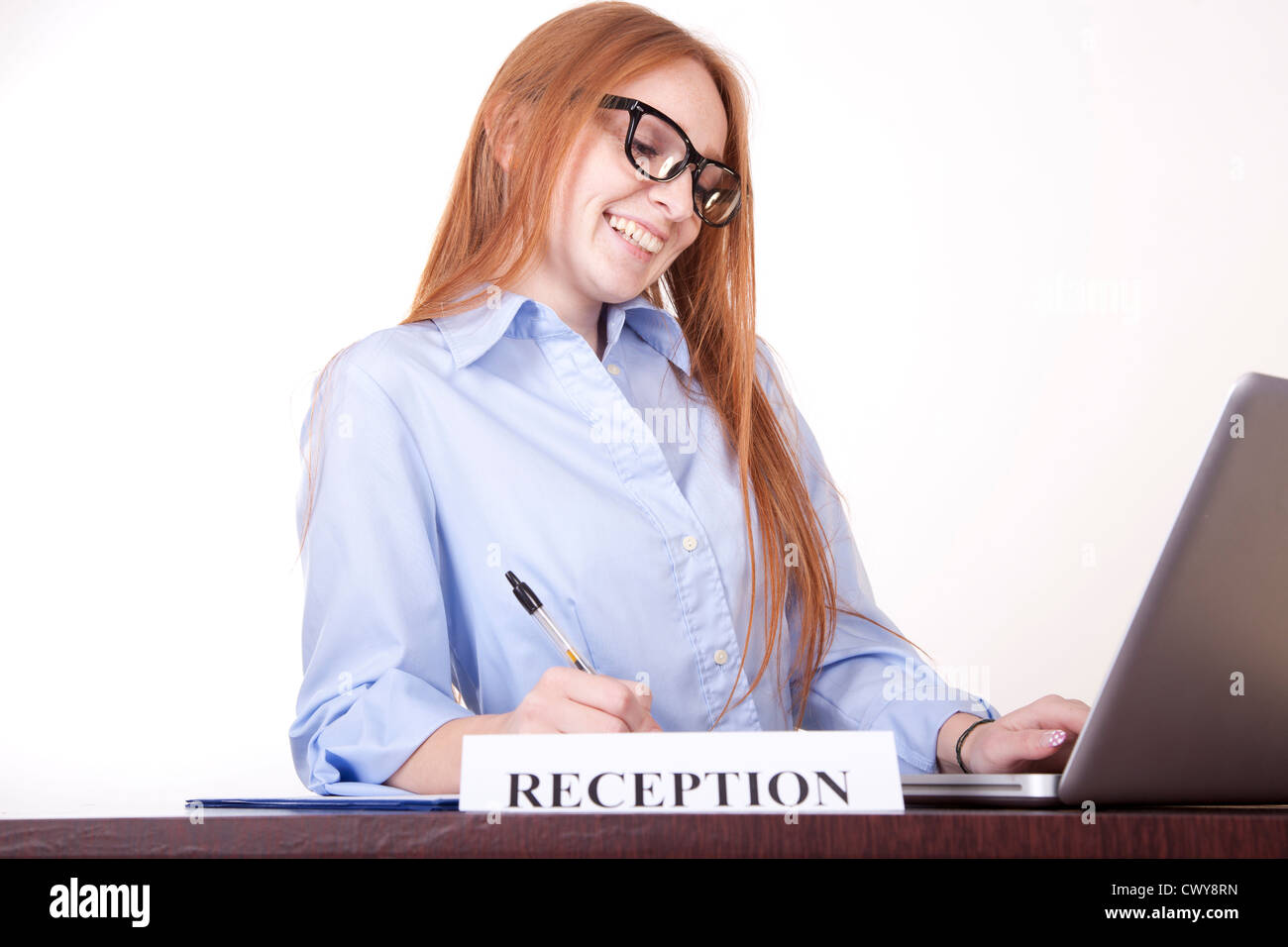 Portrait of a young attractive female receptionist smiling Stock Photo ...