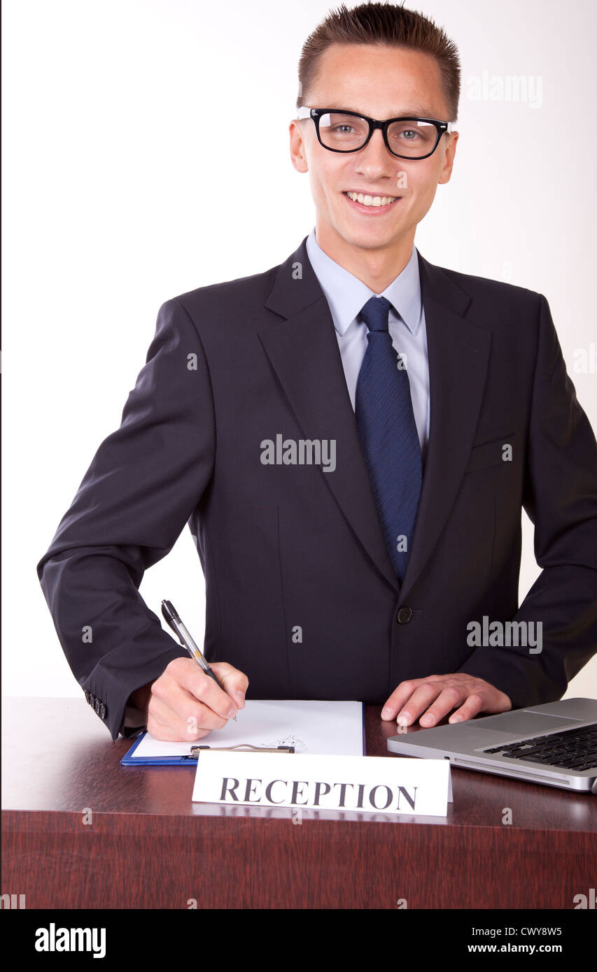 Portrait of a young attractive male receptionist smiling Stock Photo ...