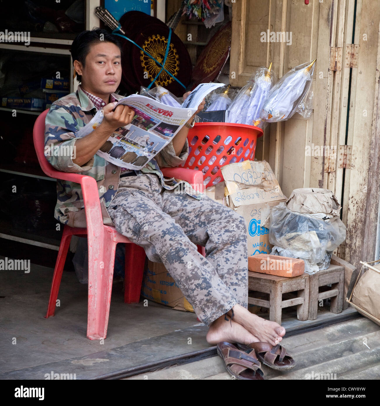 Myanmar, Burma. Mandalay. Burmese Man Reading Newspaper Stock Photo - Alamy