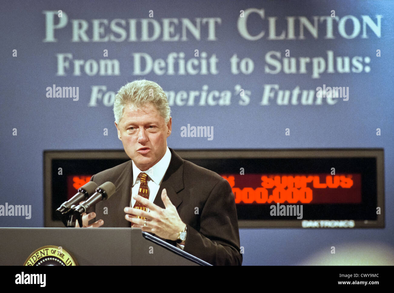 US President Bill Clinton standing in front of the new Budget Surplus ...