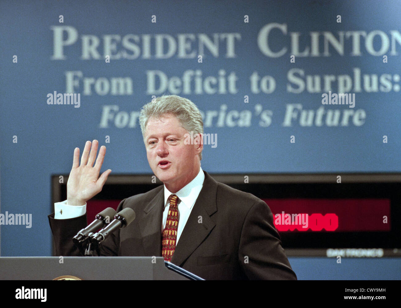 US President Bill Clinton standing in front of the new Budget Surplus ...