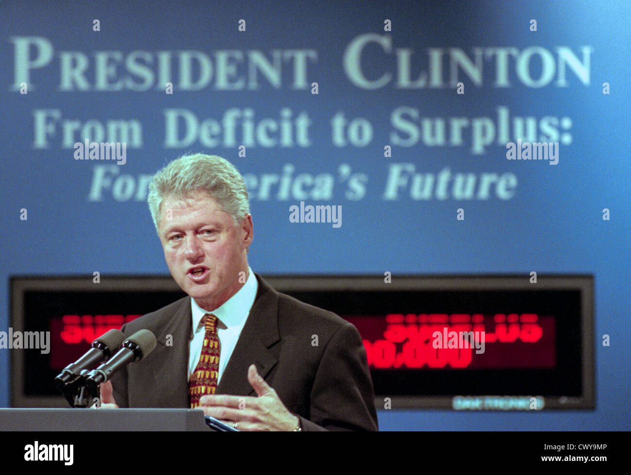 US President Bill Clinton standing in front of the new Budget Surplus ...