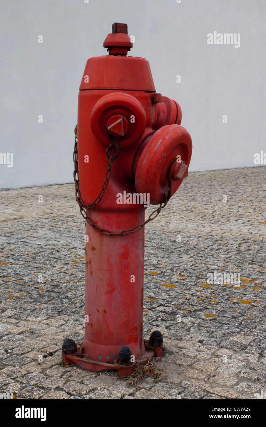 A red fire hydrant tap on a street Stock Photo - Alamy