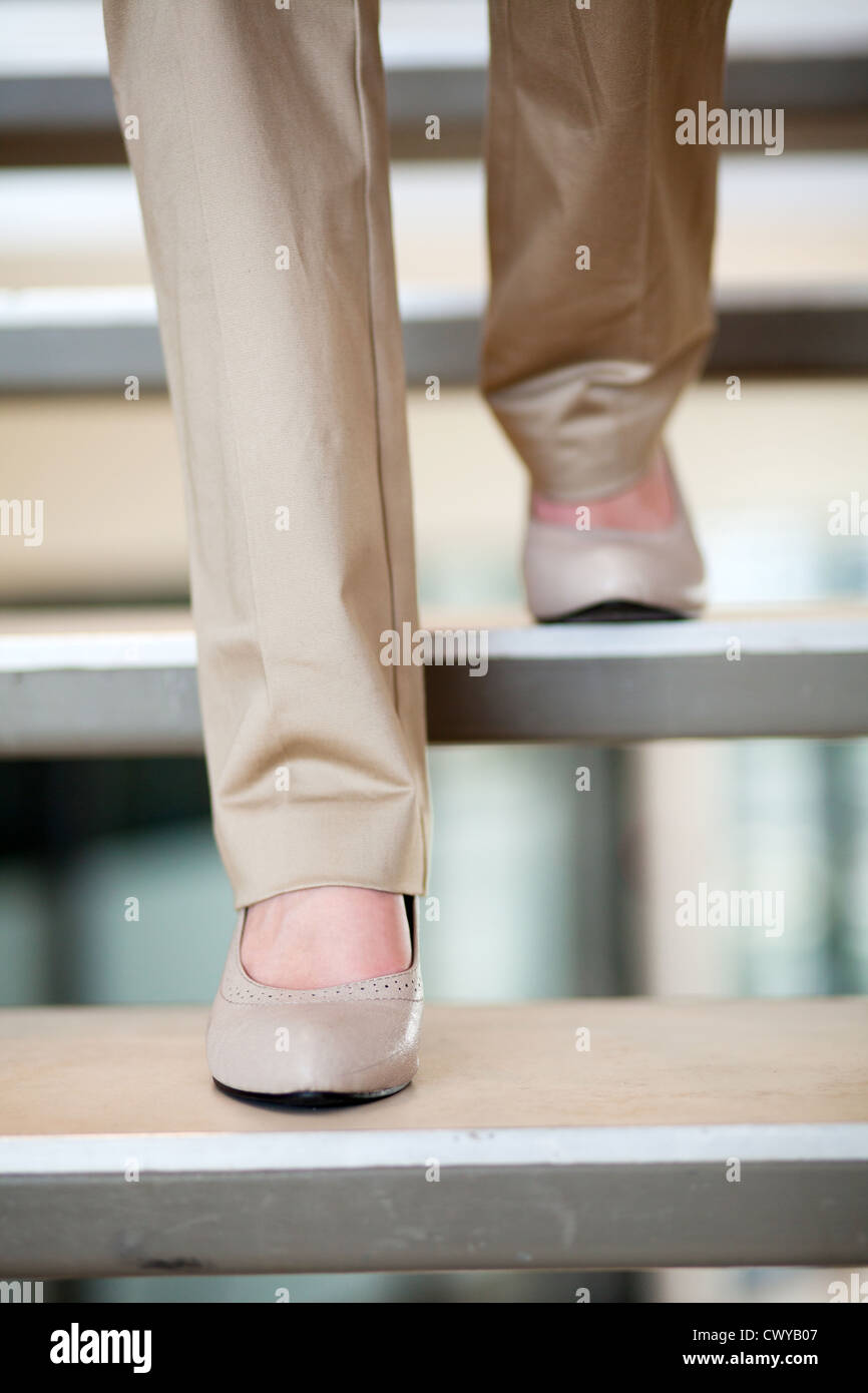 woman walking down stairs Stock Photo - Alamy