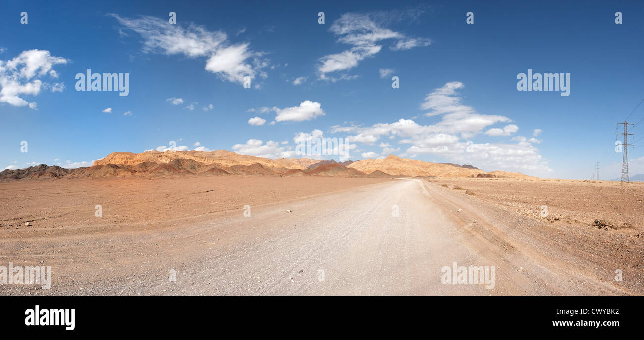 Road in the desert towards the distant rocks Stock Photo - Alamy