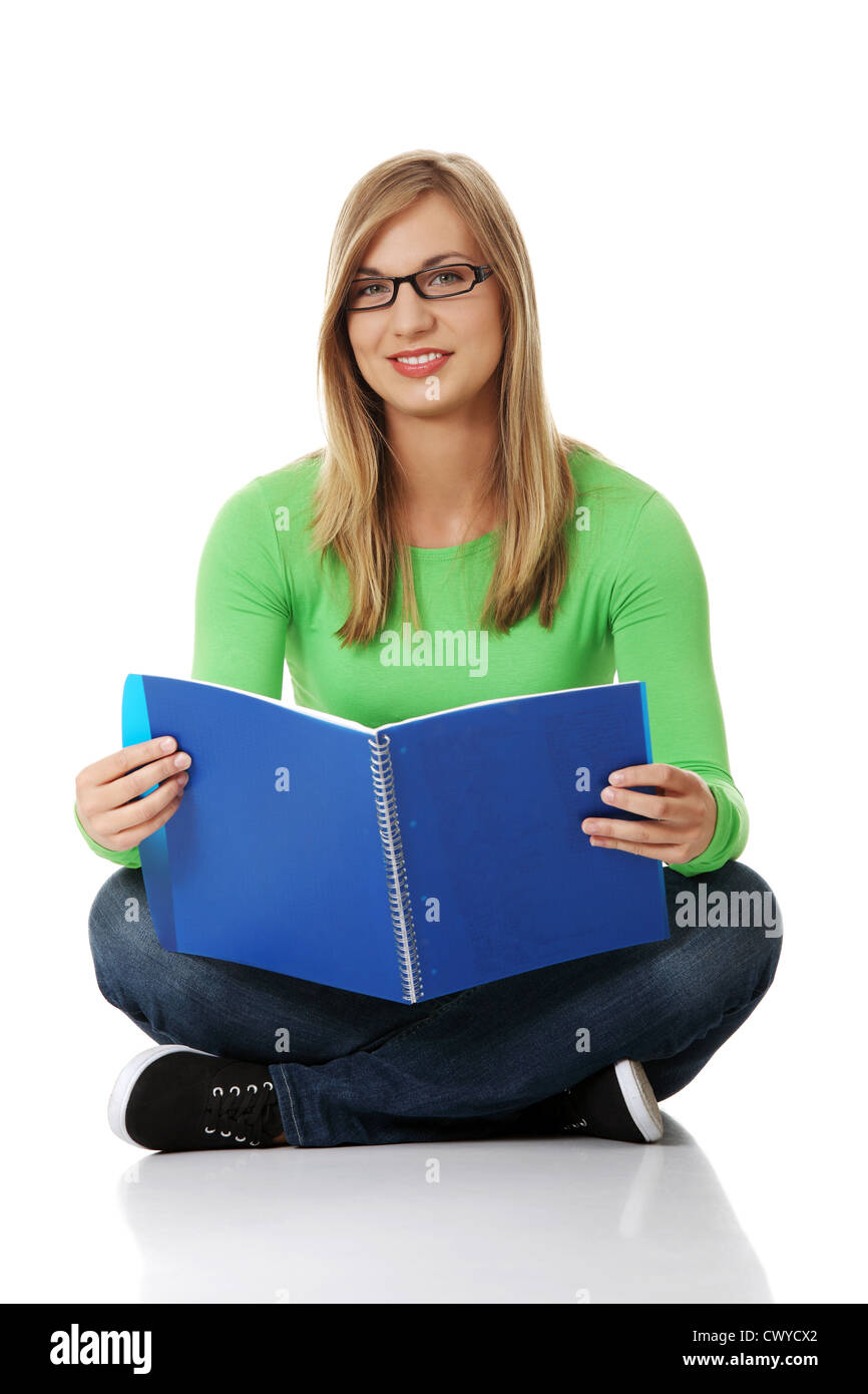 Studying thoughtful young woman reading her notebook for school Stock ...
