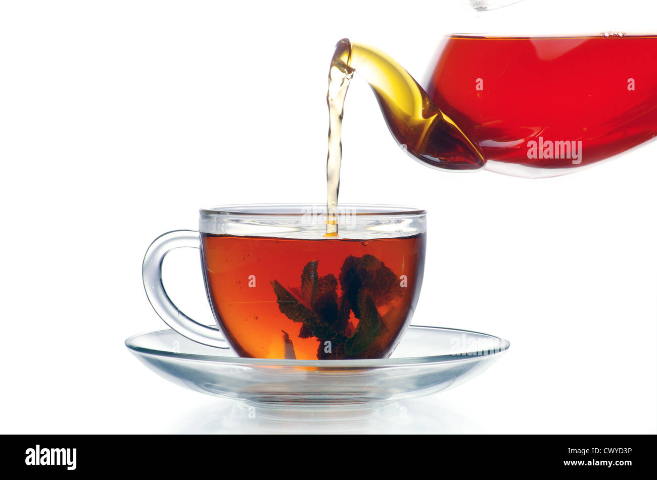 Tea being poured into glass tea cup Stock Photo - Alamy