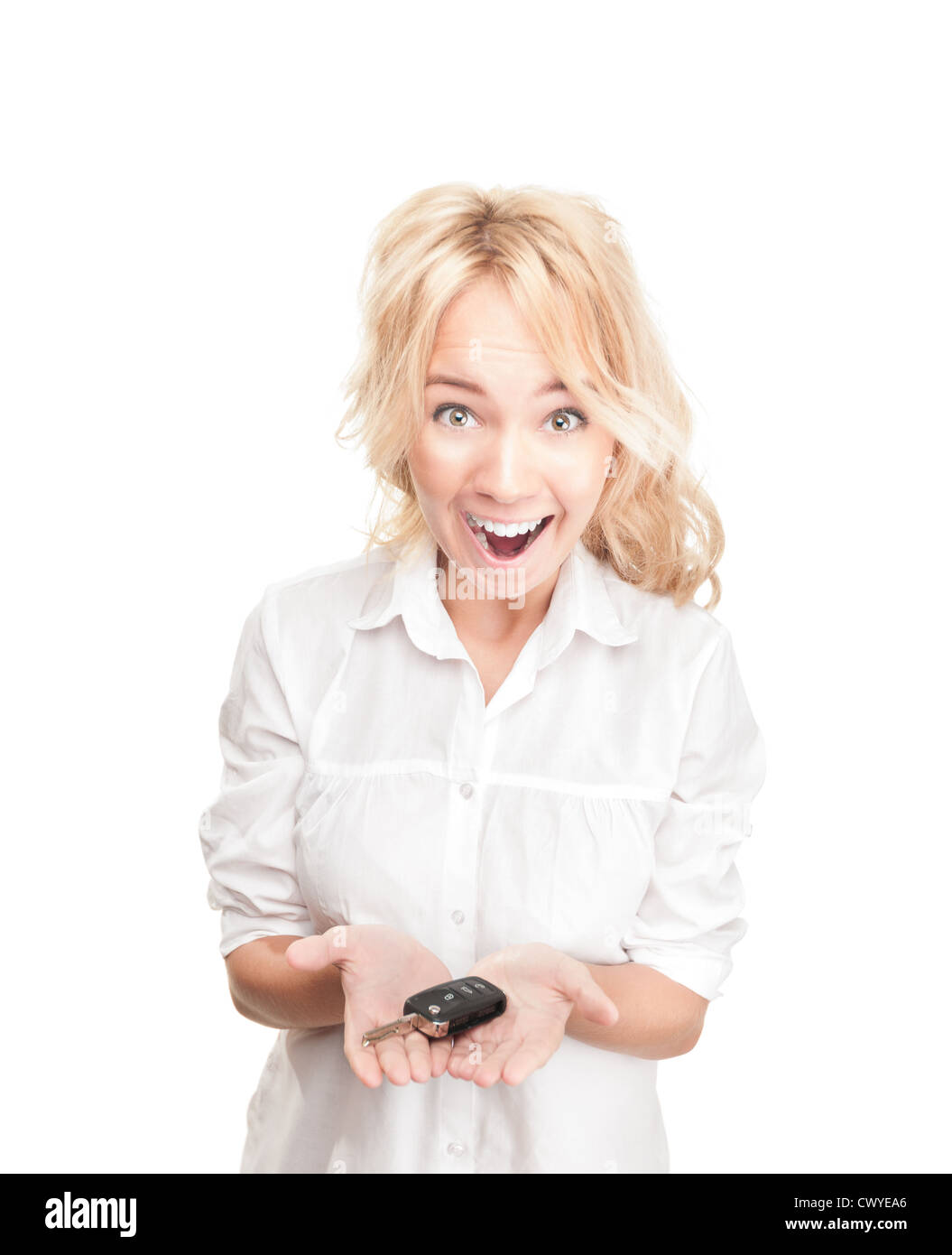 Portrait of pretty surprised young girl holding car key in her hands ...