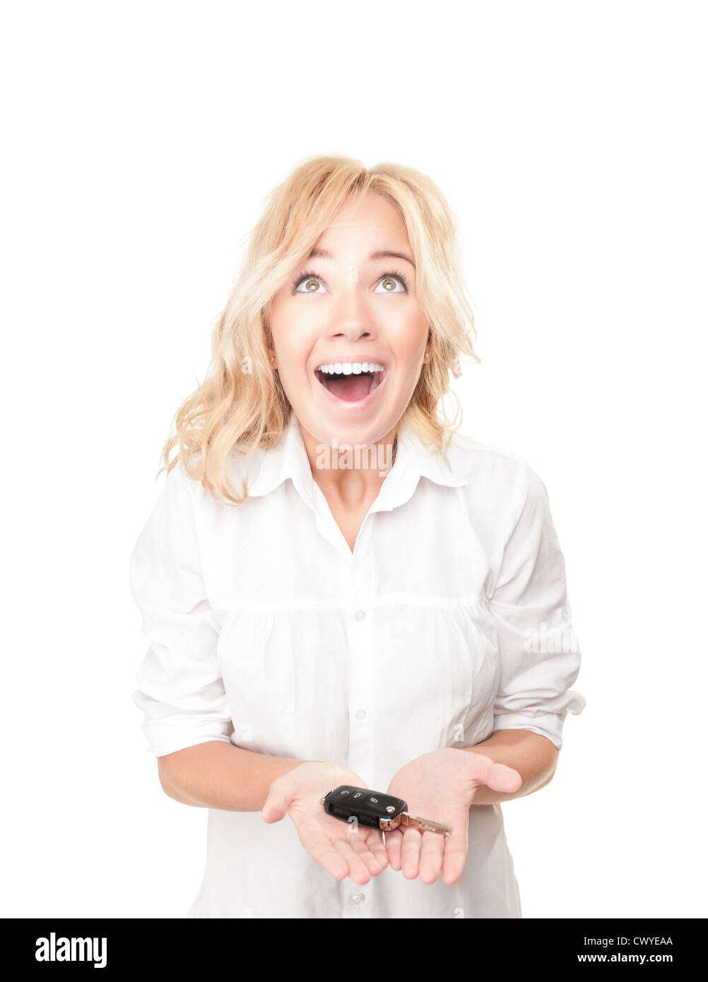 Portrait of pretty surprised young girl holding car key in her hands ...