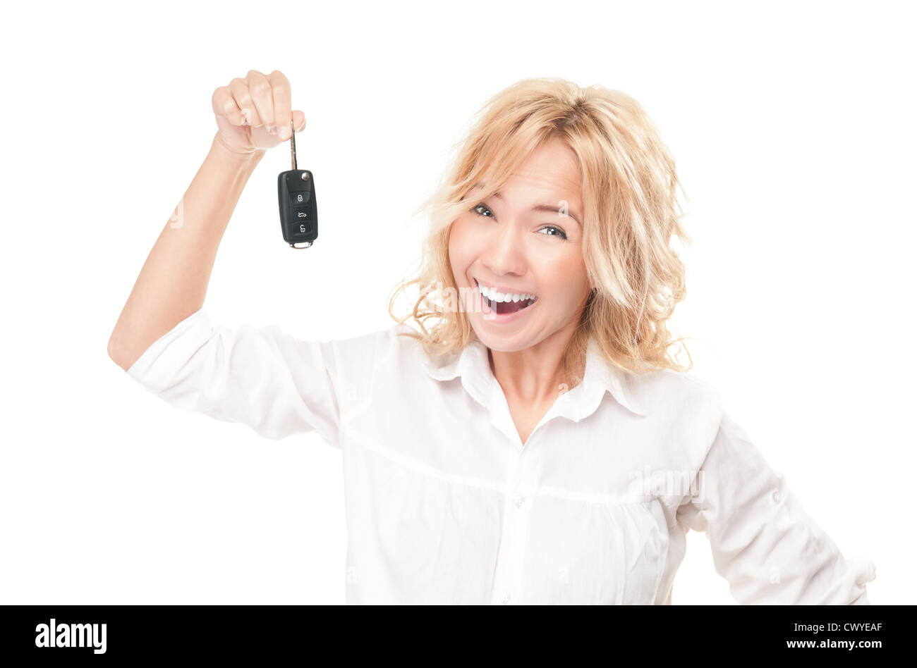 Portrait of pretty surprised young girl holding car key in her hands ...