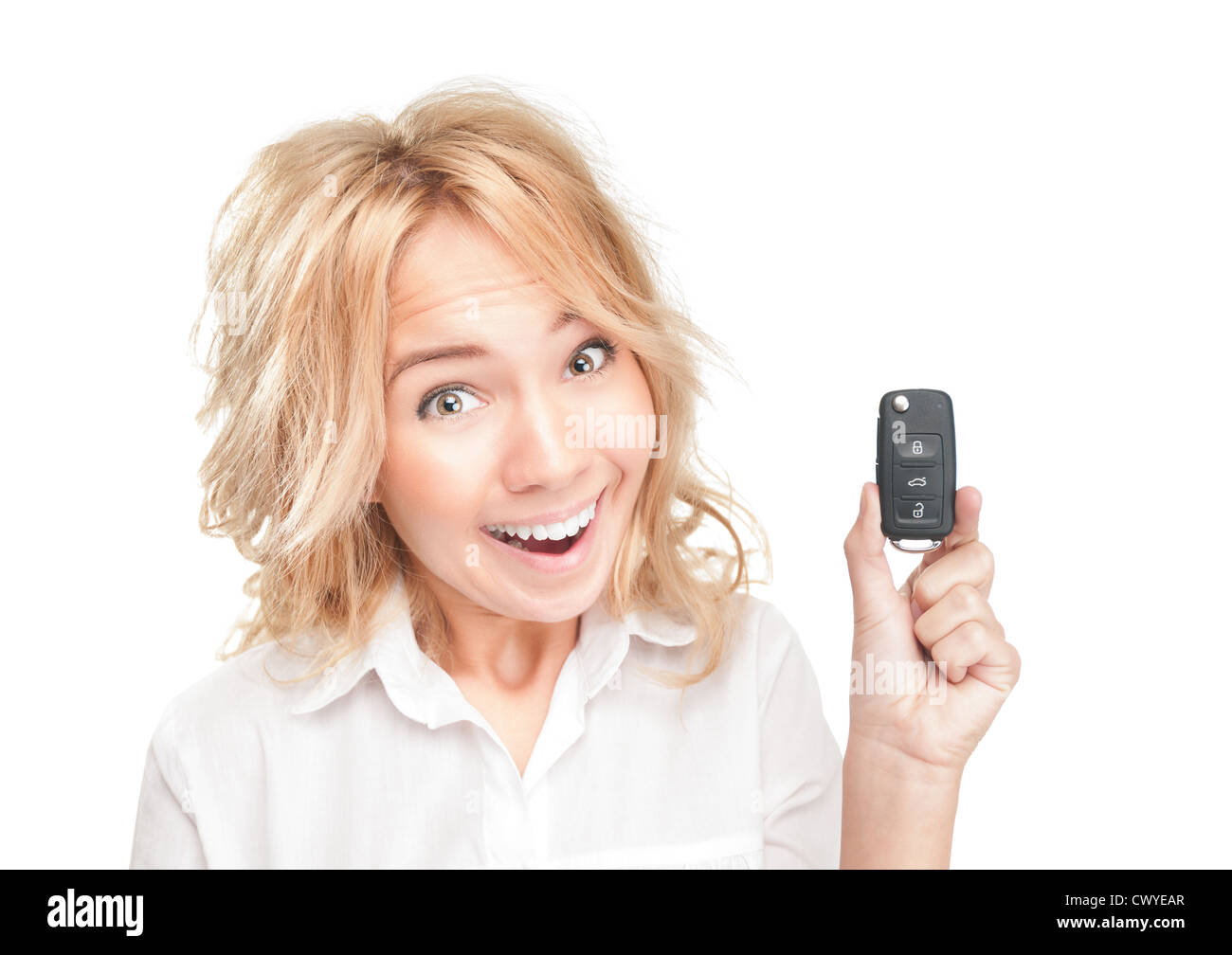 Portrait of pretty surprised young girl holding car key in her hands ...