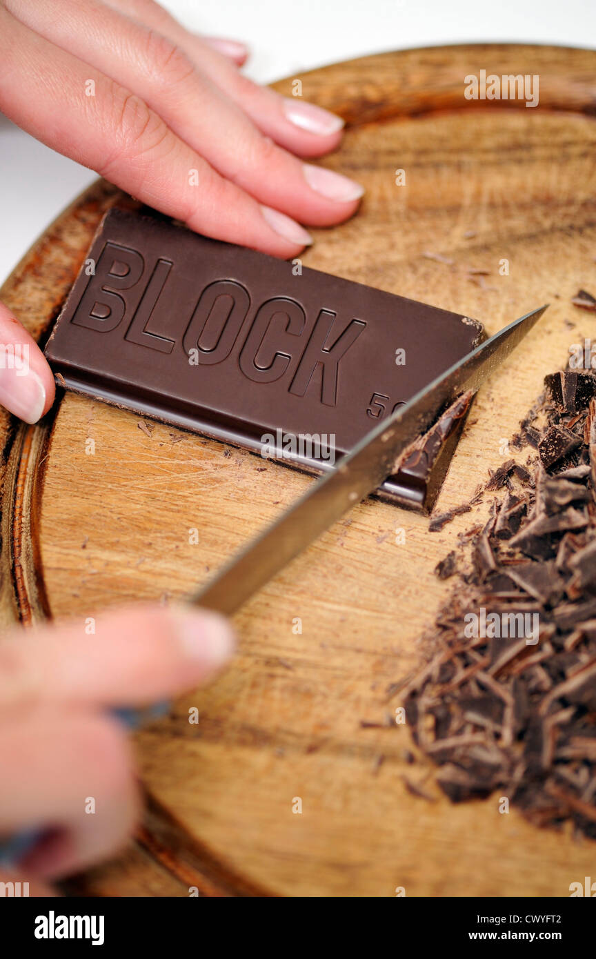 Woman cutting chocolate Stock Photo - Alamy