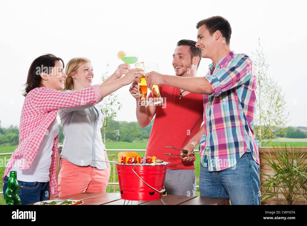 Beer glass cheers friends outside hi-res stock photography and images ...