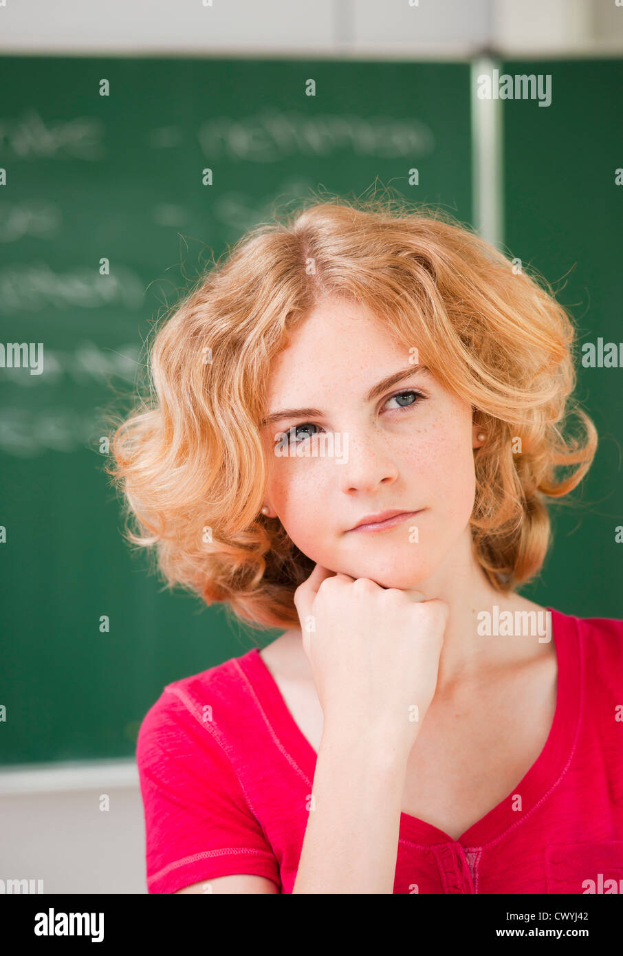 Thoughtful teenage girl in classroom, portrait Stock Photo - Alamy