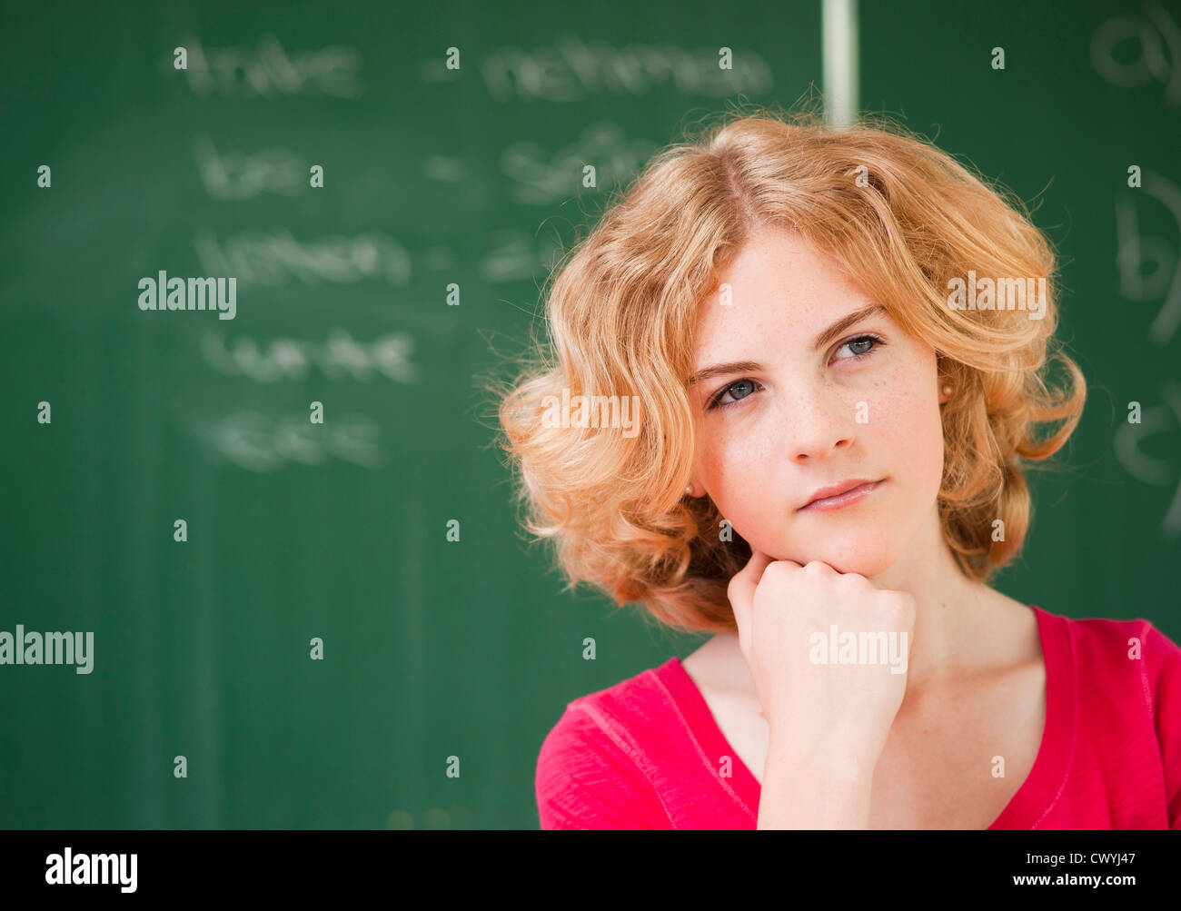 Thoughtful teenage girl in classroom, portrait Stock Photo - Alamy