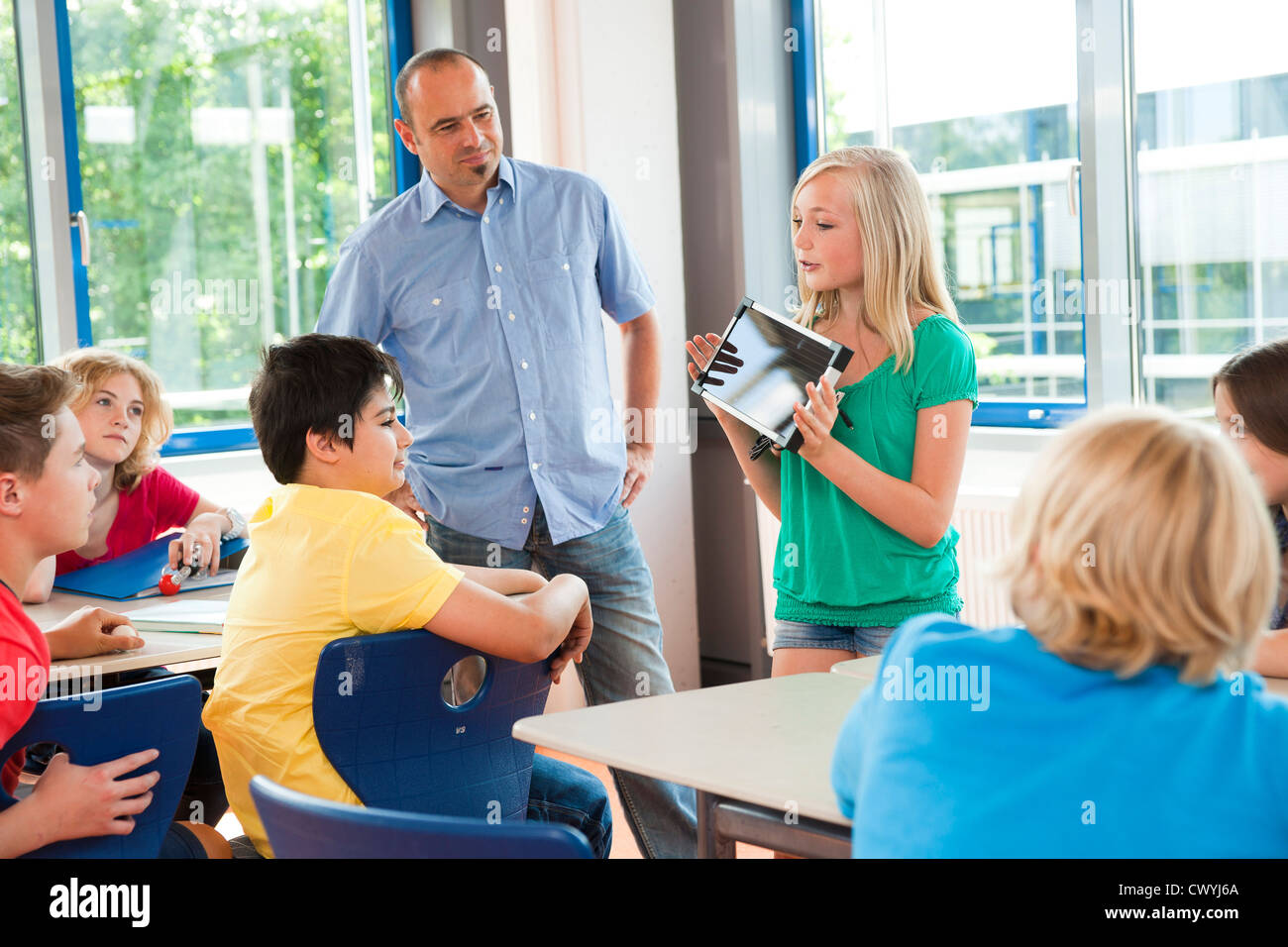 Schoolgirl explaining solar panel in class Stock Photo - Alamy