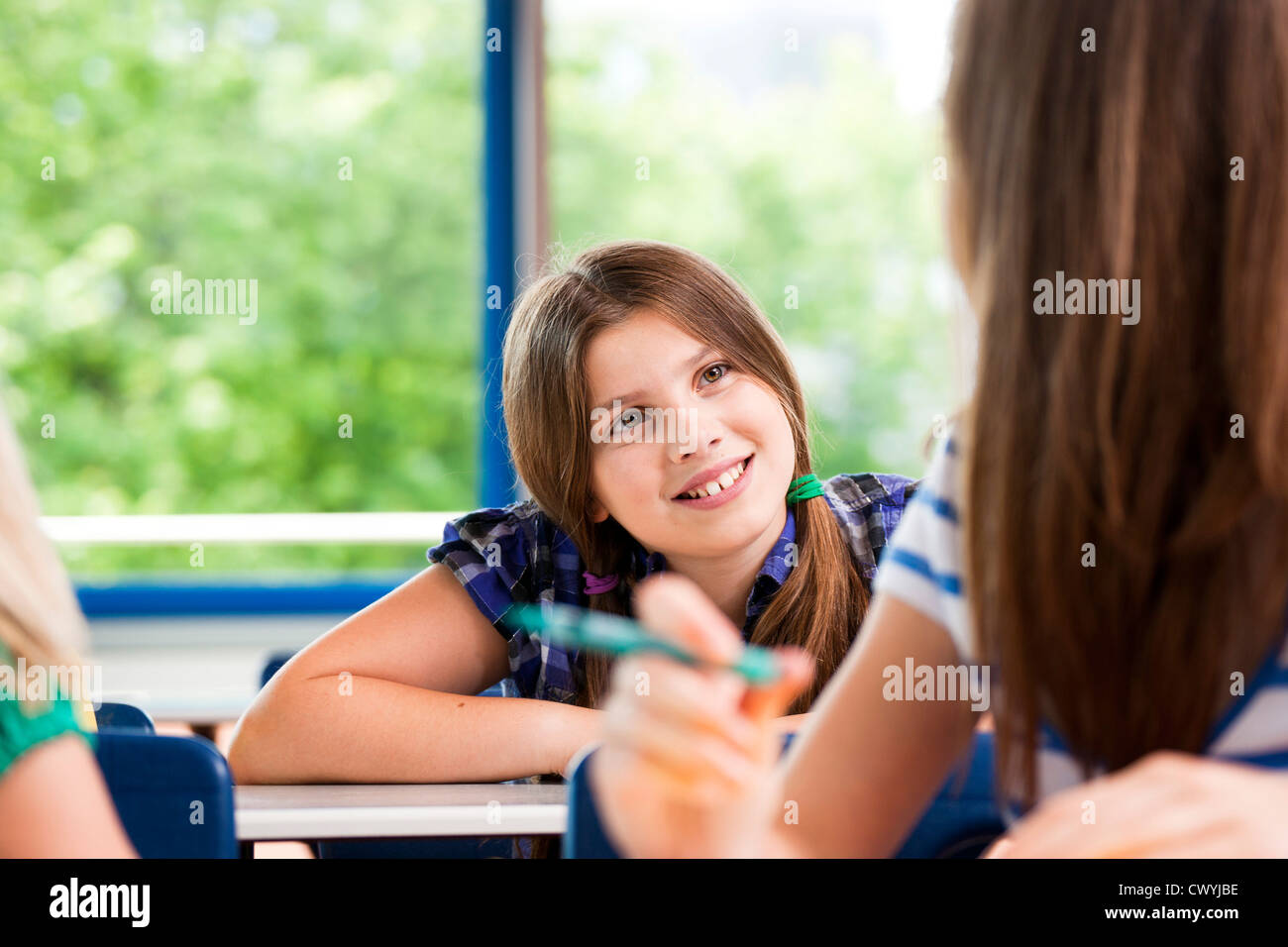 Smiling girl in classroom Stock Photo - Alamy