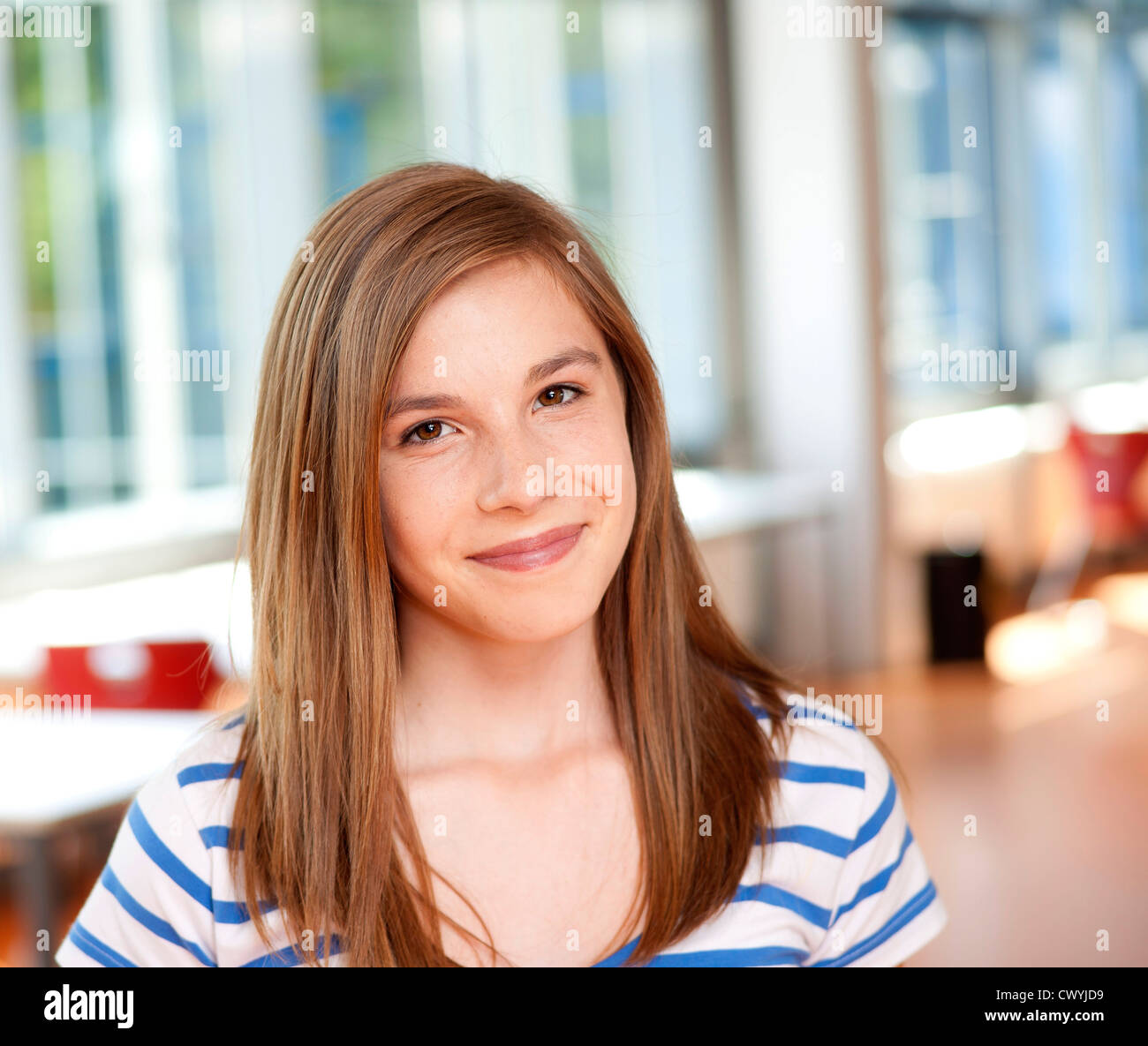Smiling teenage girl in school, portrait Stock Photo - Alamy