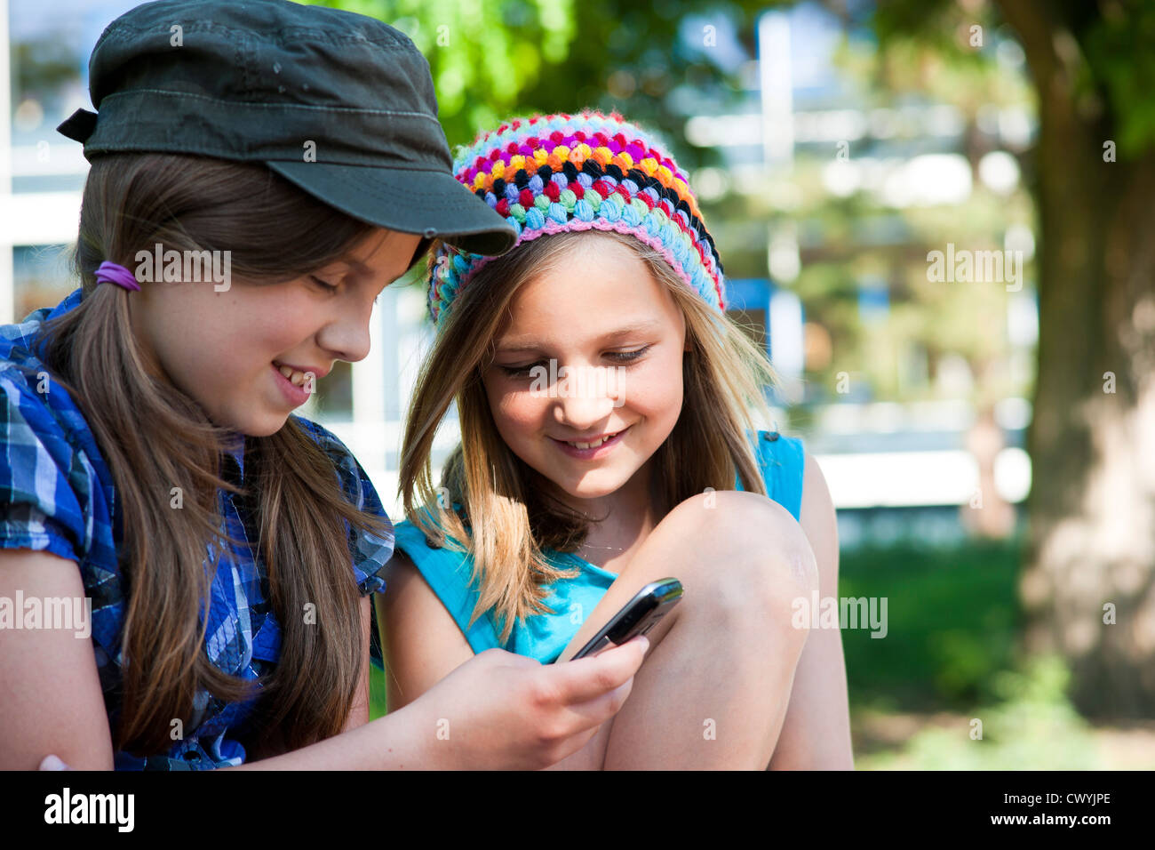 Two Girls Sit Phone High Resolution Stock Photography and Images - Alamy