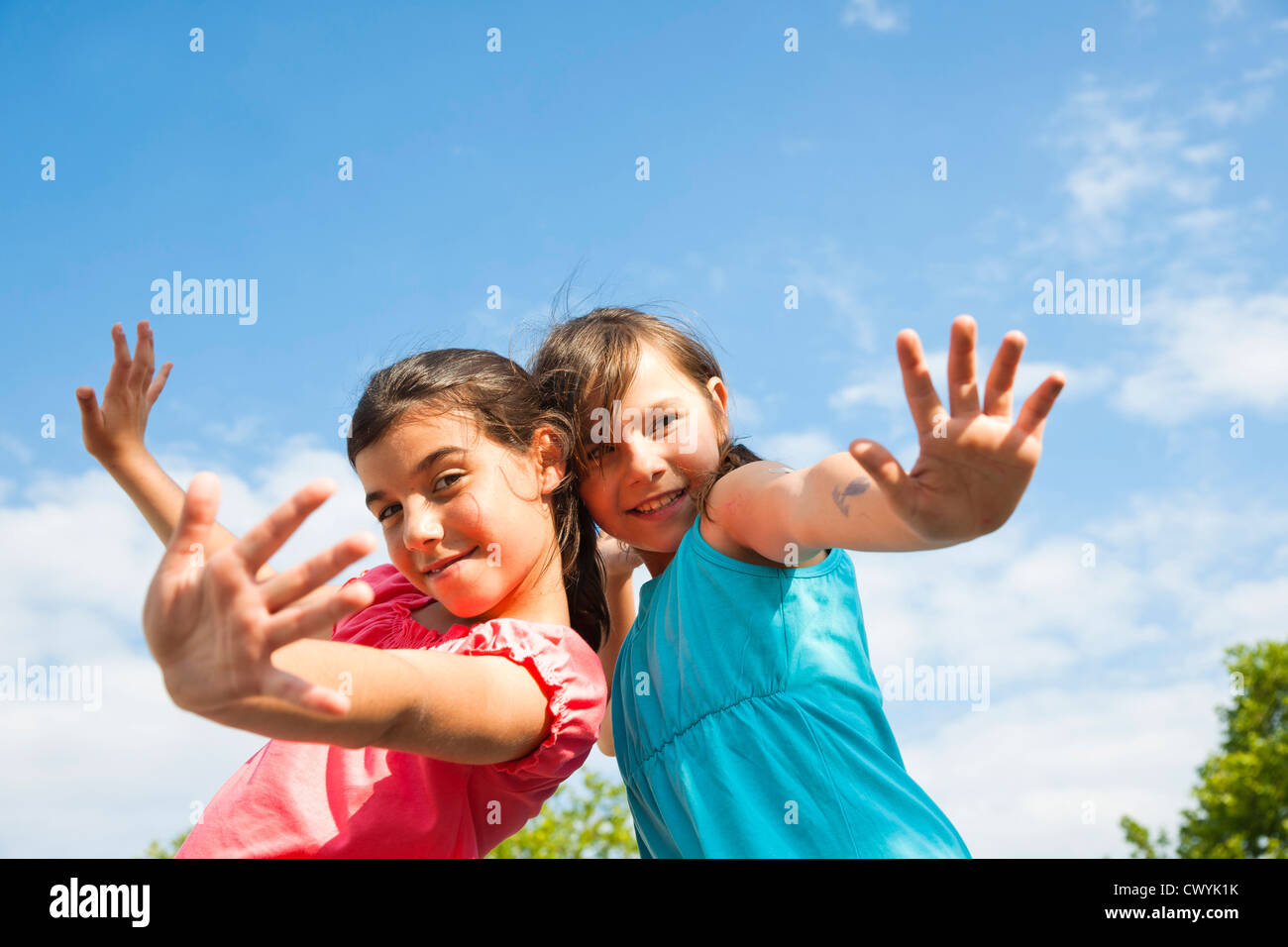 Two happy girls posing outdoors Stock Photo - Alamy