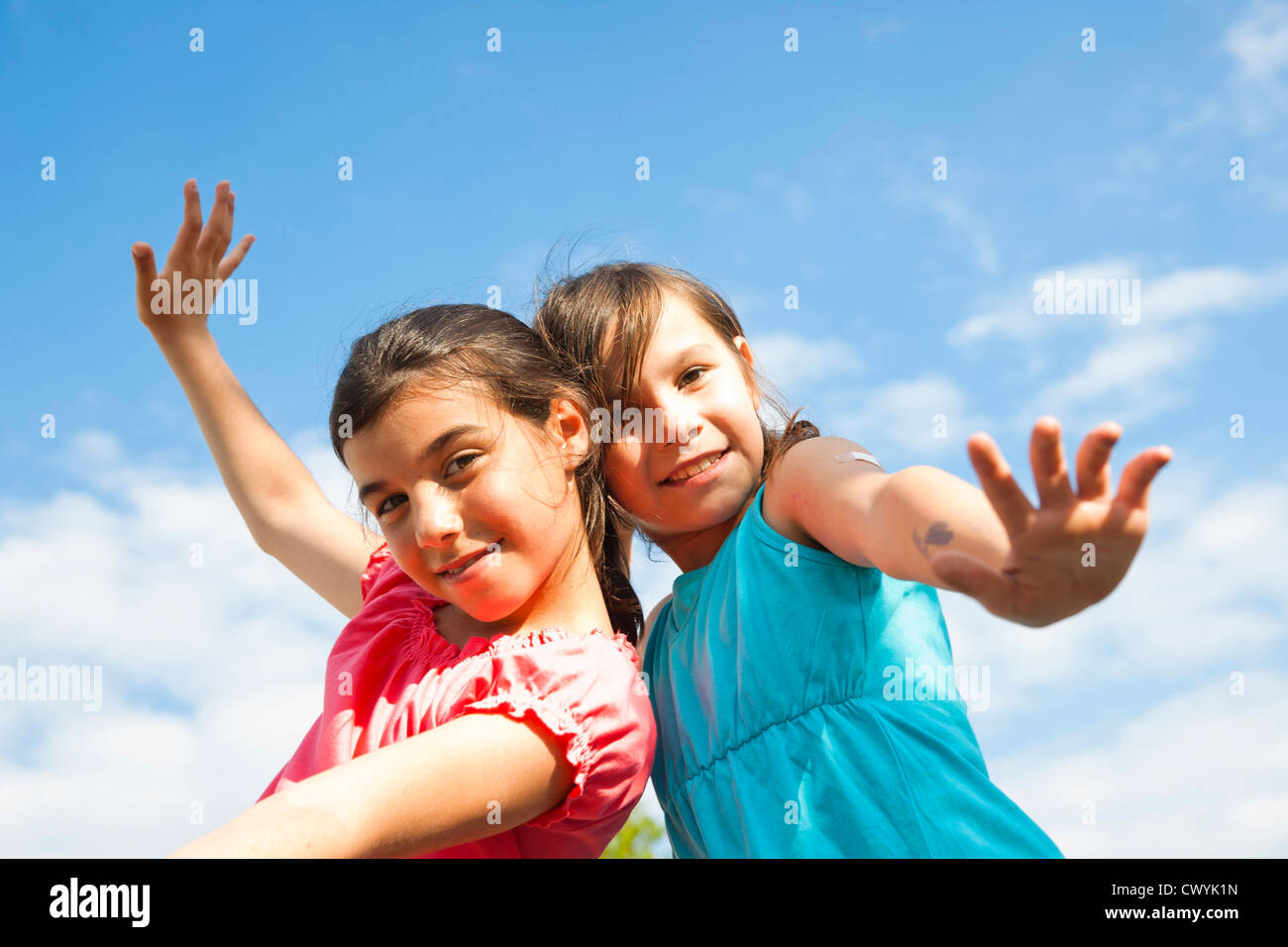 Two happy girls posing outdoors Stock Photo - Alamy