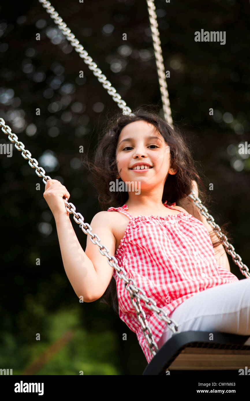 Happy girl on swing Stock Photo - Alamy