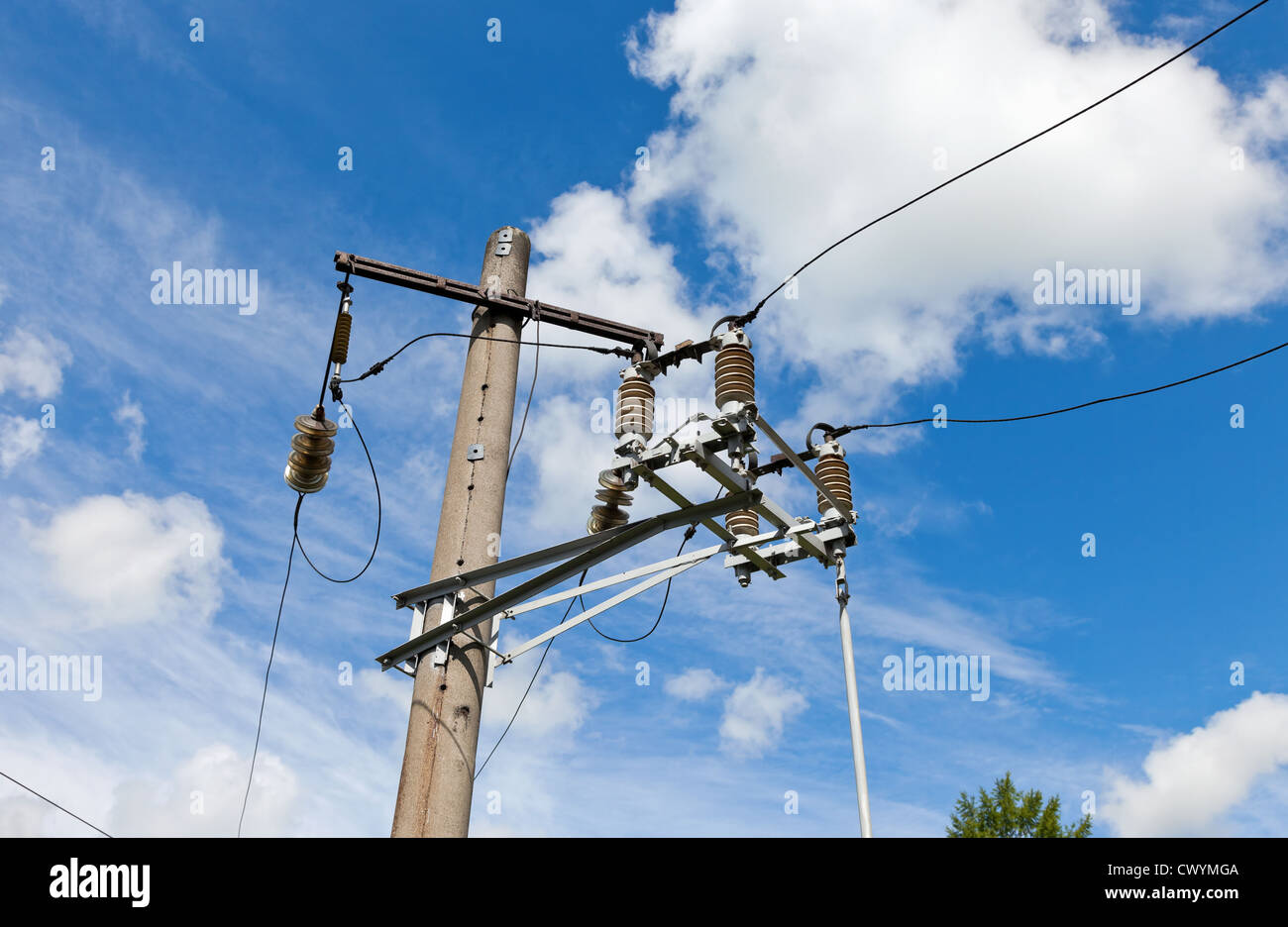 Electric power post with wire against bright blue sky and clouds Stock ...