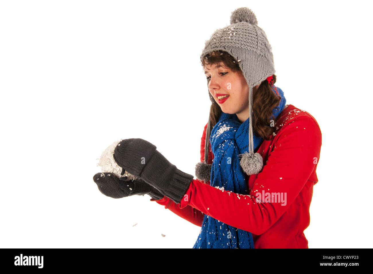 Winter girl in red and blue is throwing snow ball Stock Photo - Alamy