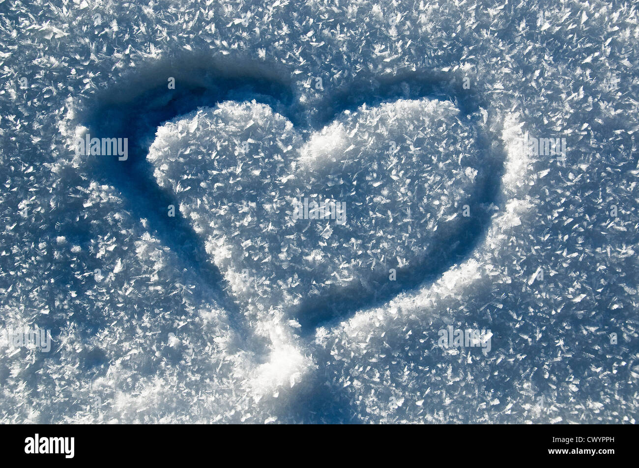 Heart in snow Stock Photo - Alamy